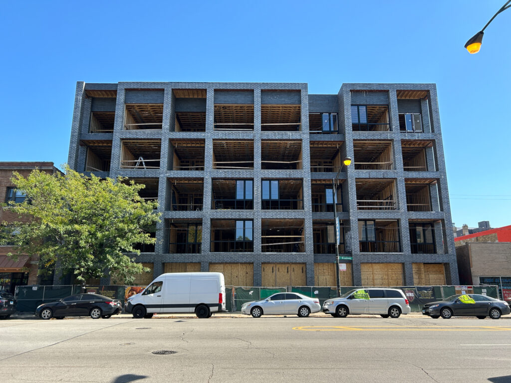 Glass installation in the early stages at topped-out 5753 North ...